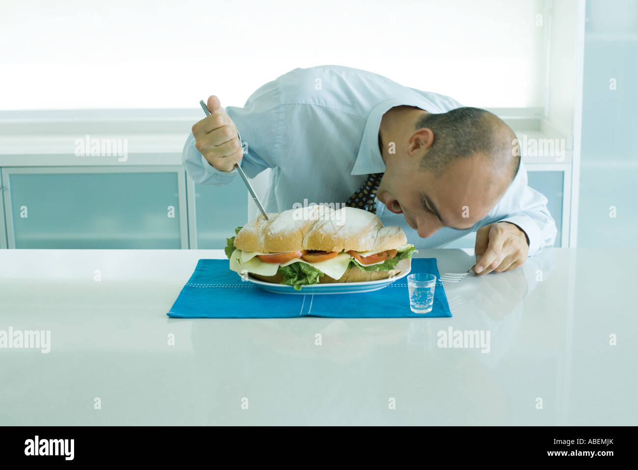 Man biting into large sandwich Stock Photo - Alamy
