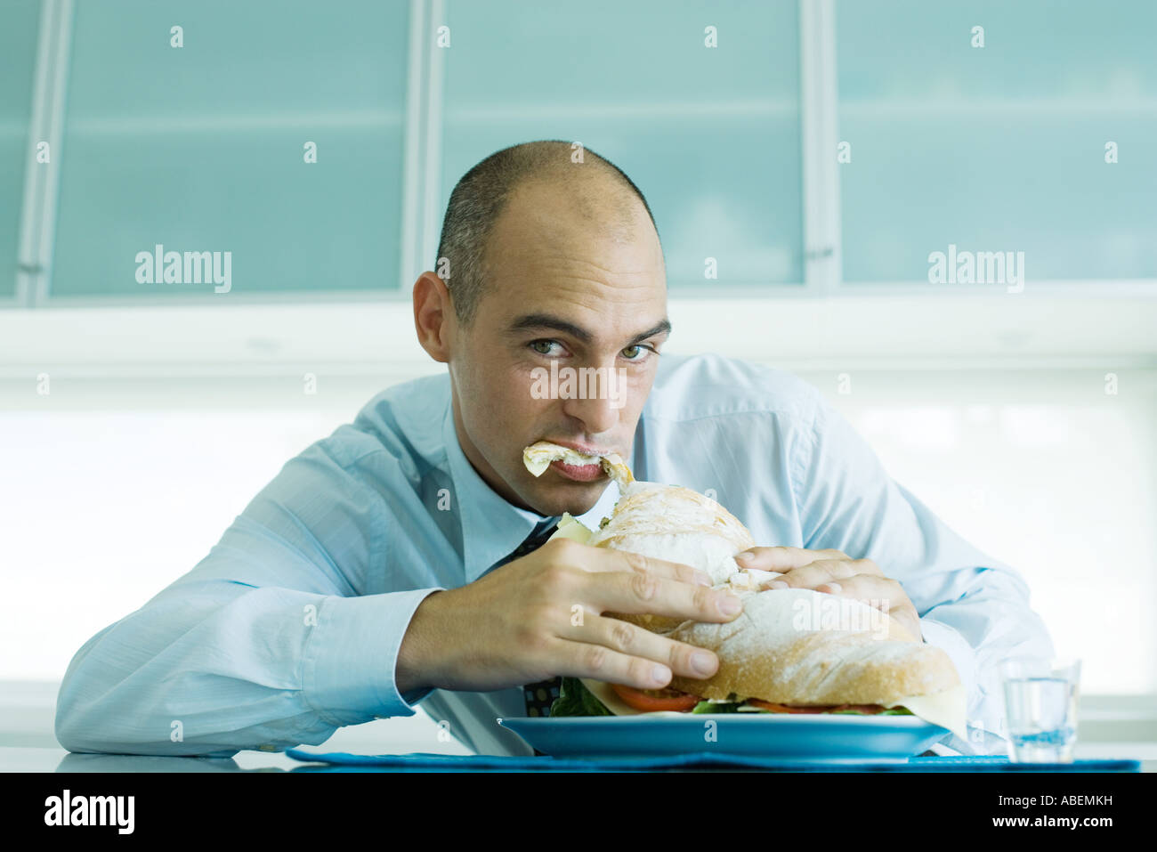 Man biting into large sandwich Stock Photo - Alamy