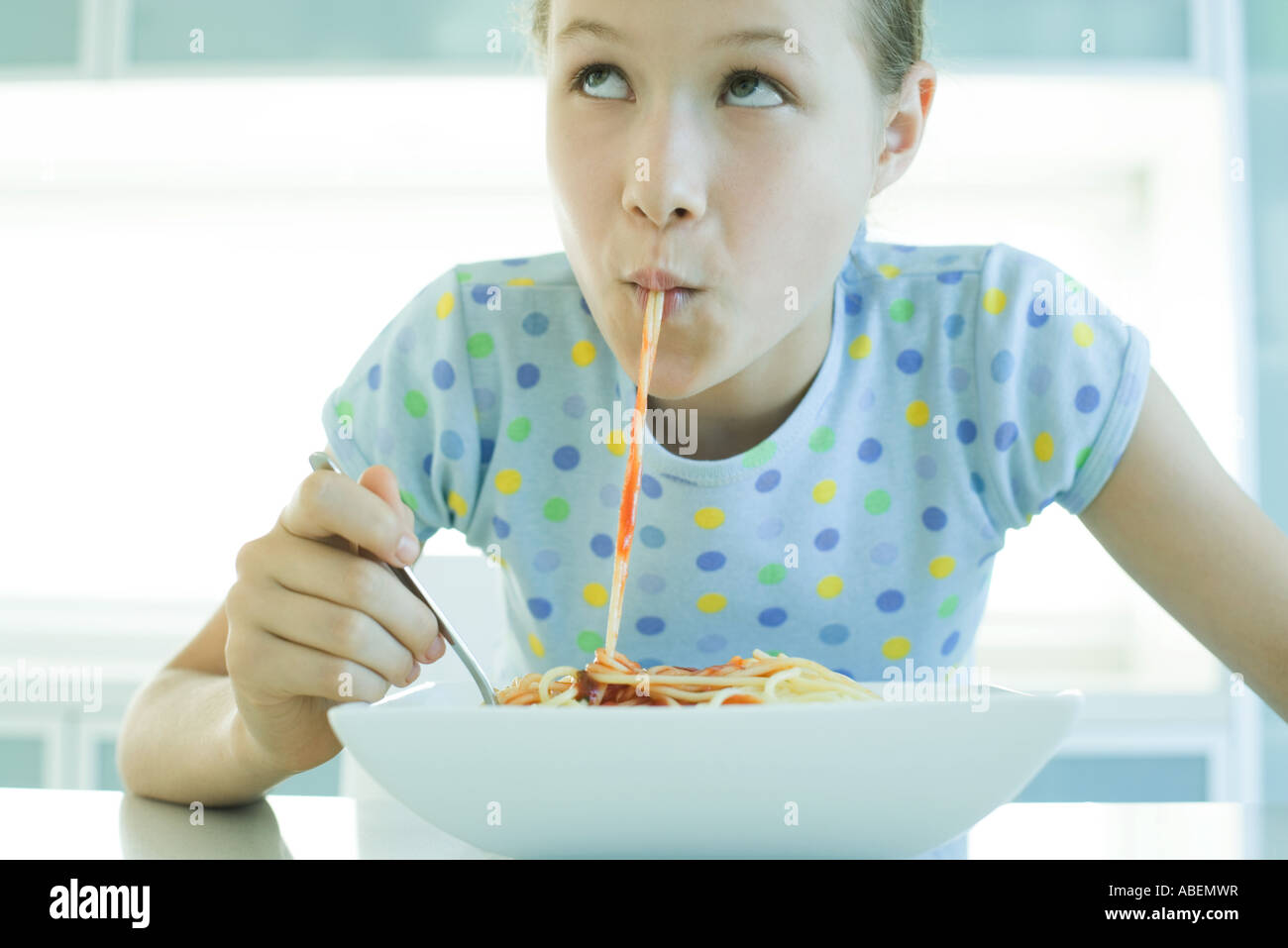 Girl slurping spaghetti noodles Stock Photo - Alamy