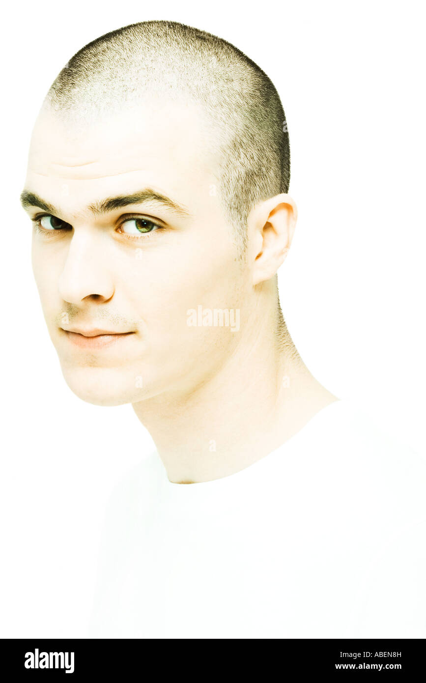 Young man looking at camera, head and shoulders, portrait Stock Photo ...