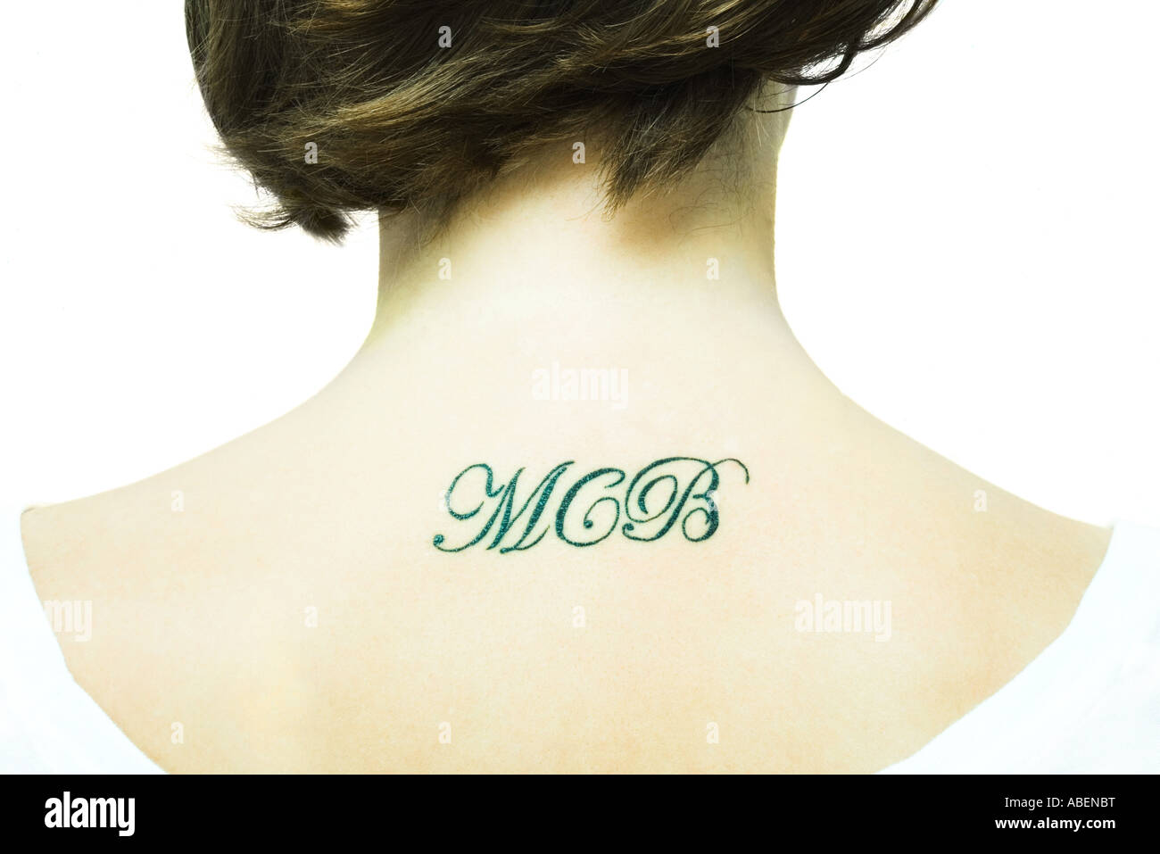 Teenage girl with initial's tattooed onto upper back, close-up Stock ...