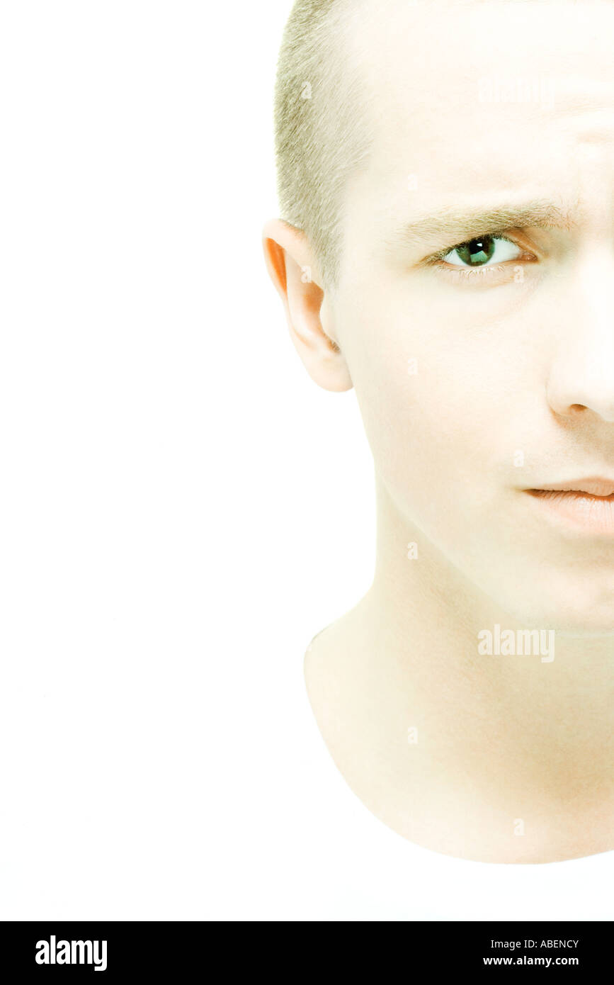 Young man furrowing brow at camera Stock Photo - Alamy