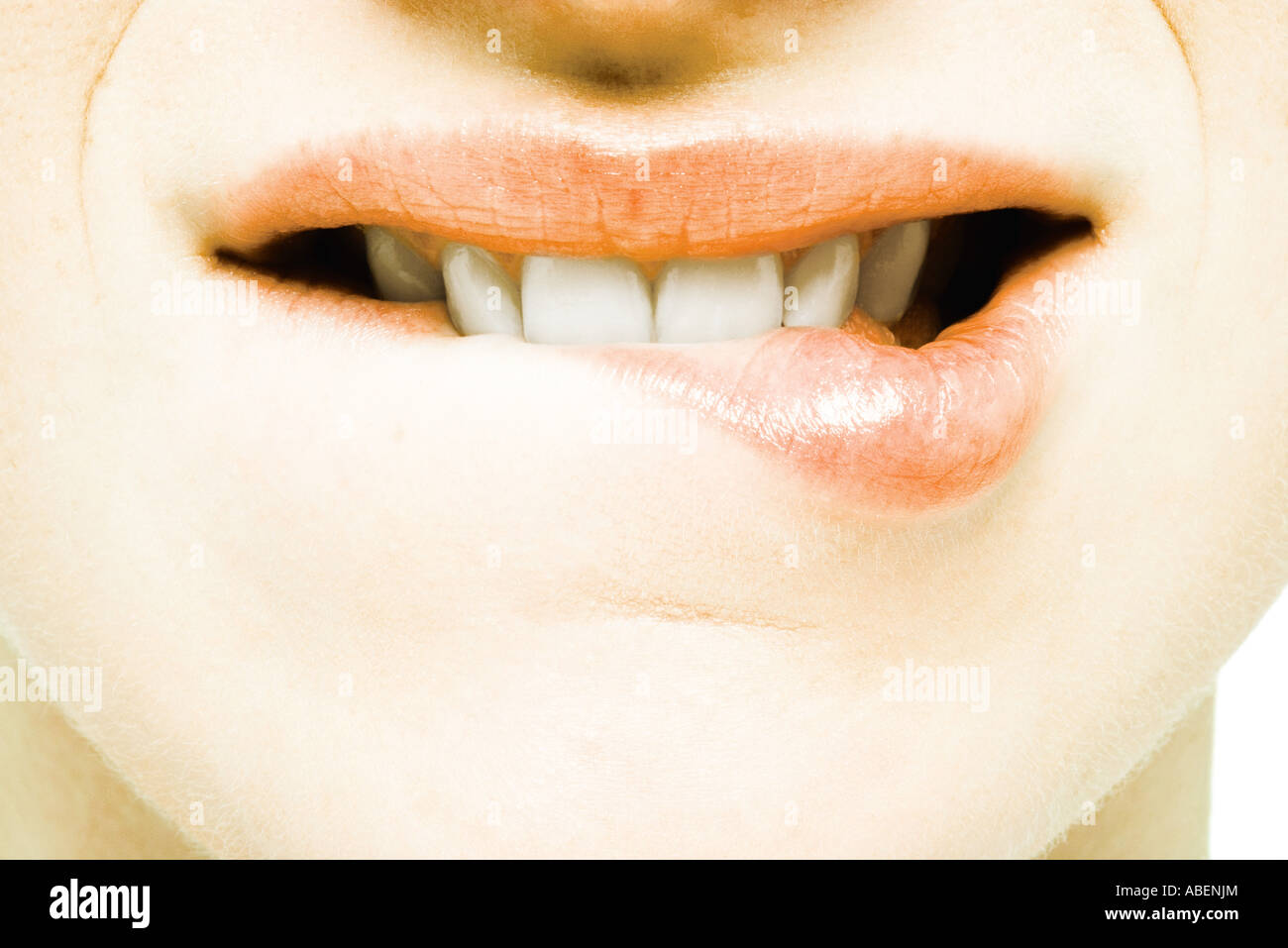 Teenage girl biting lip, extreme close-up Stock Photo - Alamy