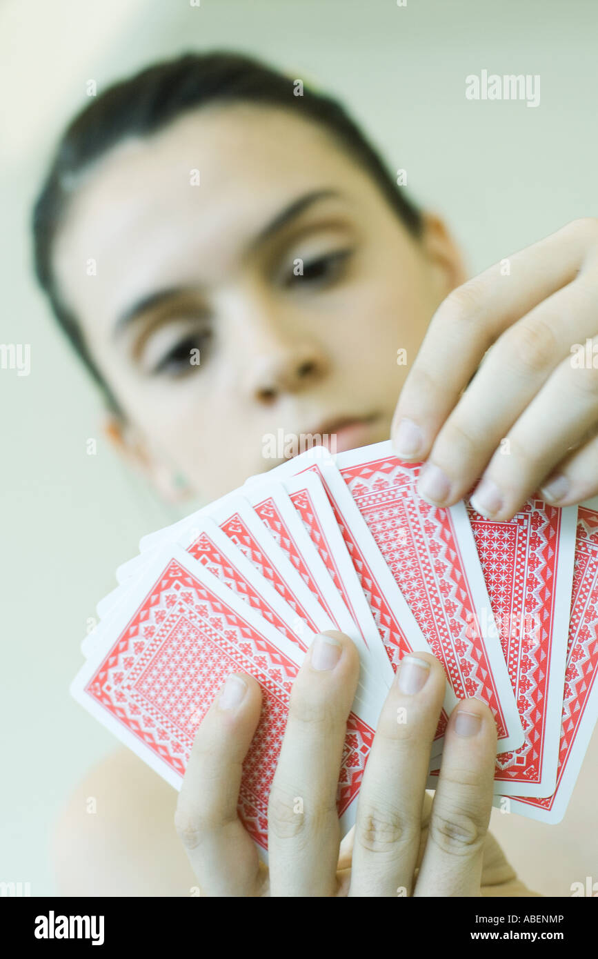 Teen girl holding hand of cards Stock Photo - Alamy