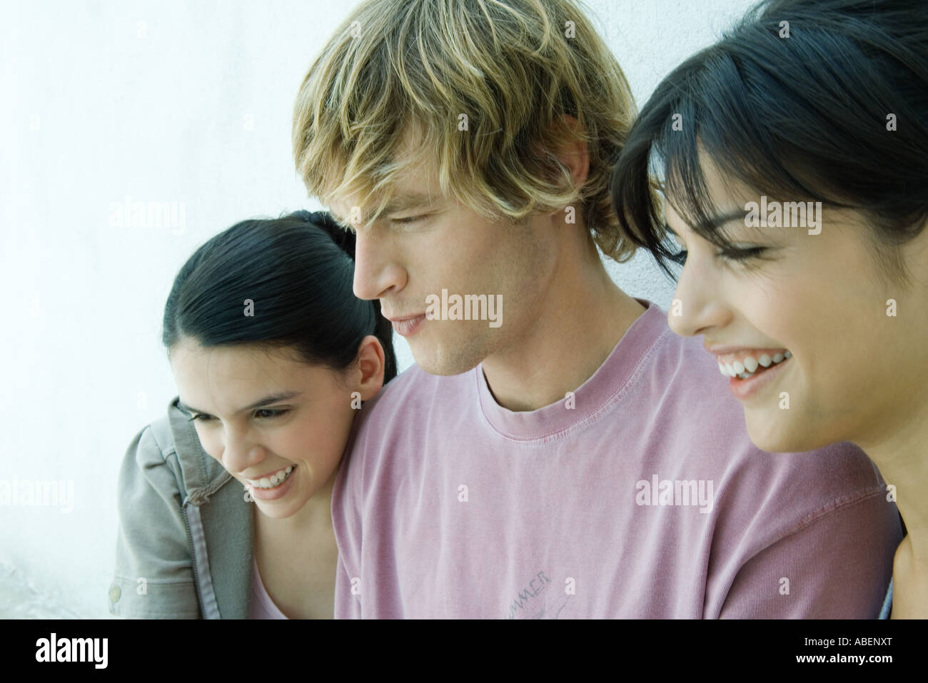 Young friends looking out of frame, side view Stock Photo - Alamy