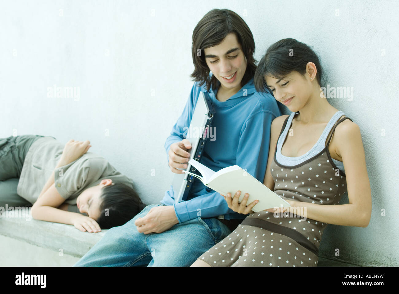 Young friends reading book together Stock Photo - Alamy