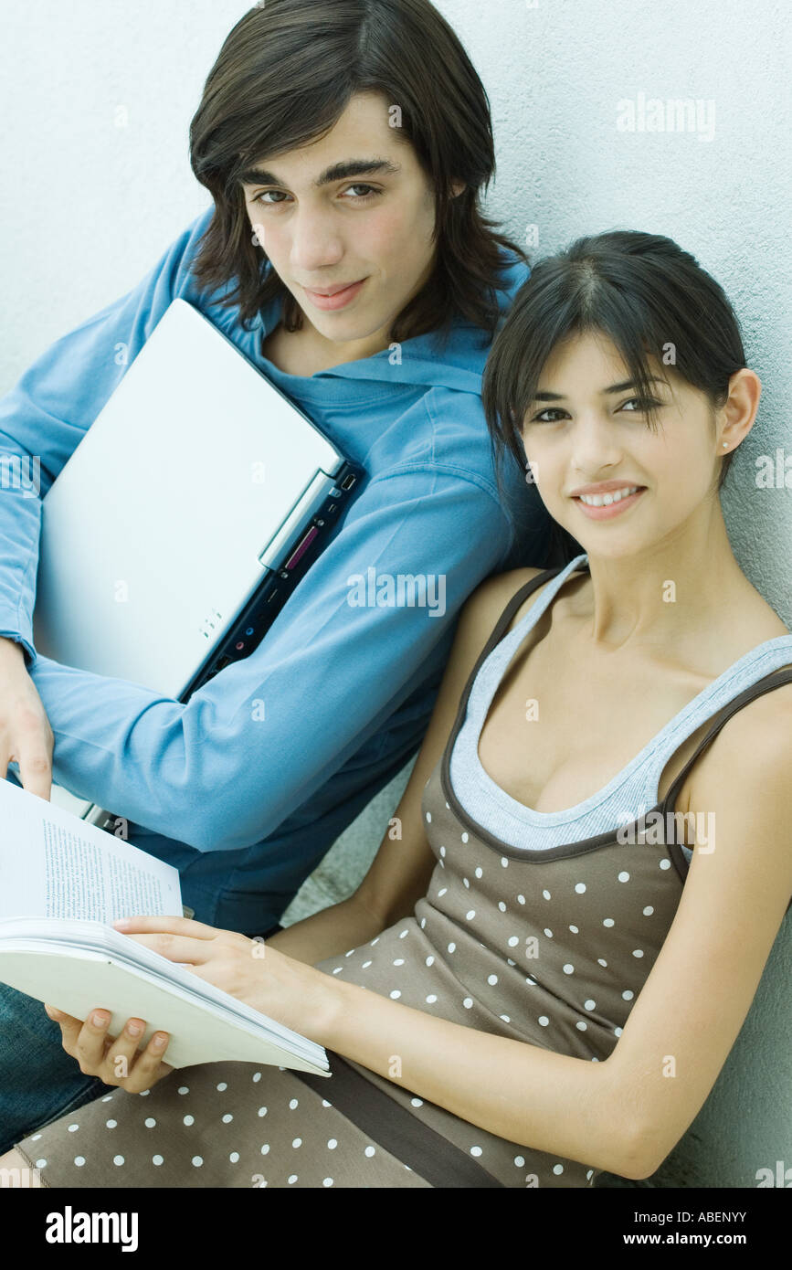 Young friends reading book together Stock Photo - Alamy