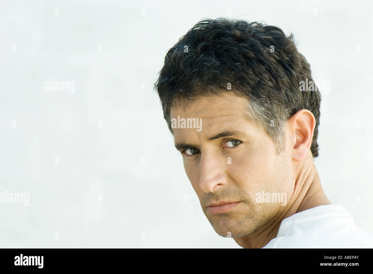 Man, looking over shoulder at camera, portrait Stock Photo - Alamy