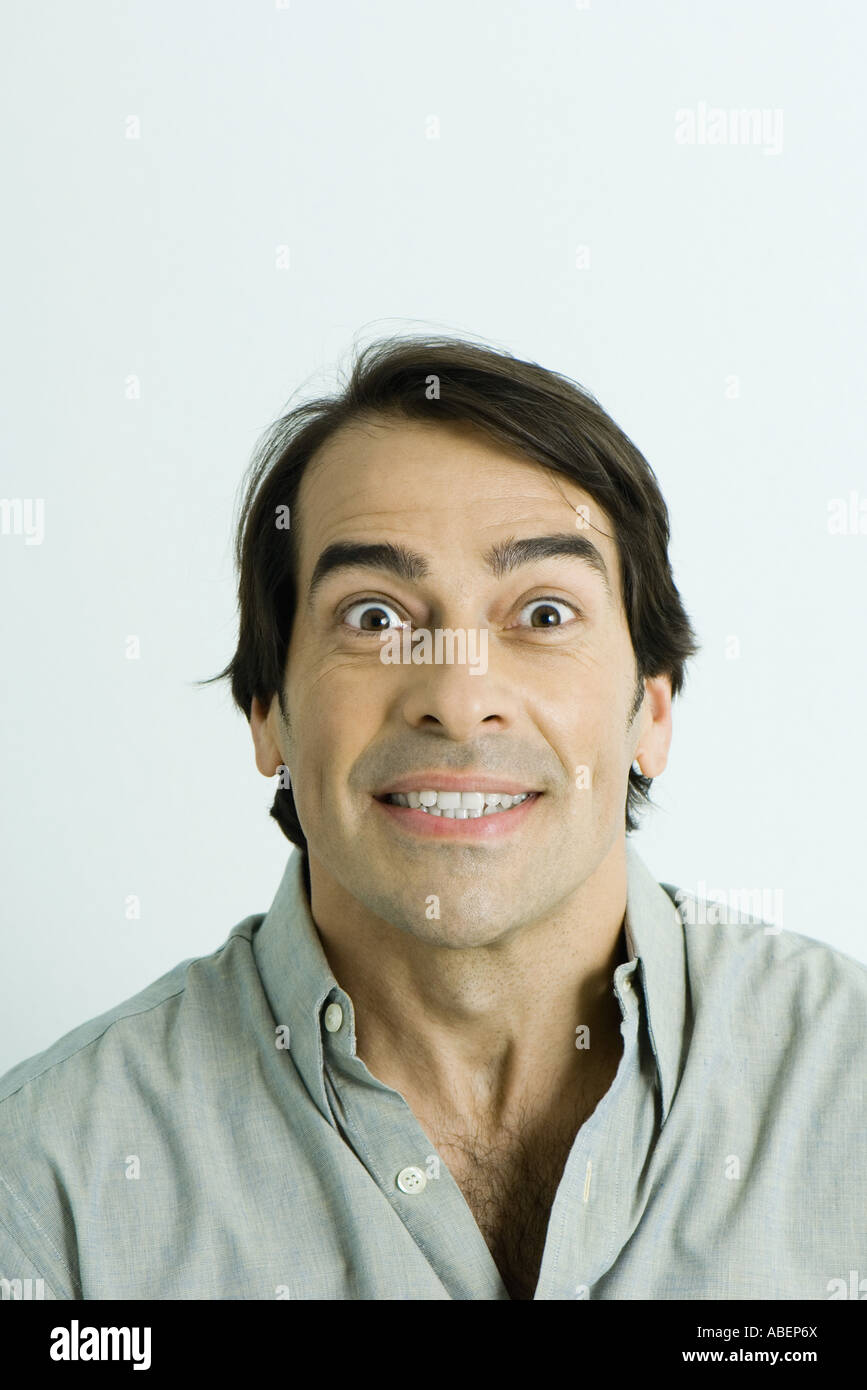 Man, smiling, eyes wide open, portrait Stock Photo - Alamy