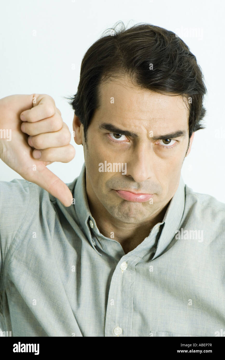 Man giving thumbs down sign, portrait Stock Photo - Alamy