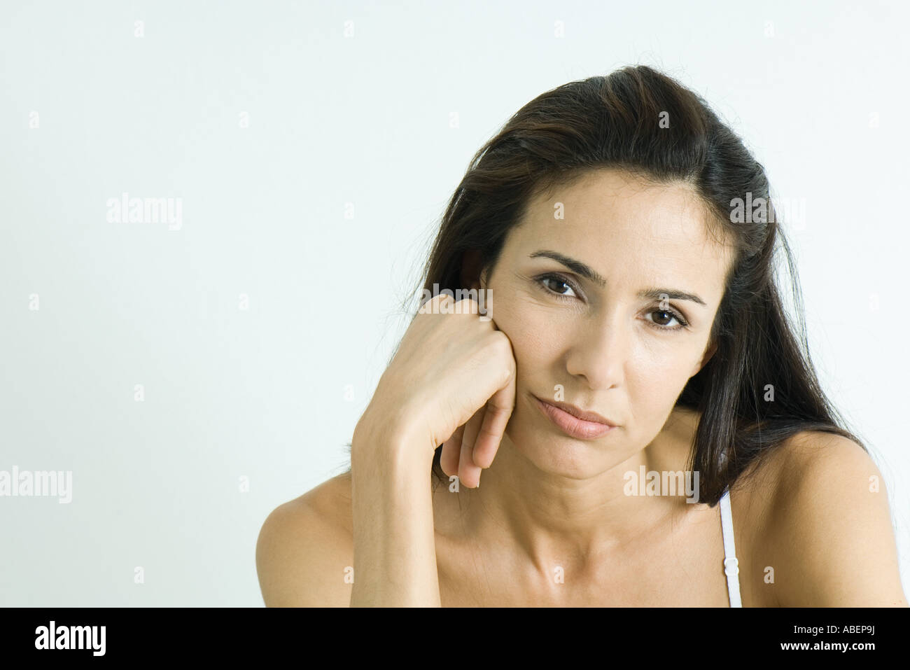 Woman holding head, pouting, portrait Stock Photo - Alamy