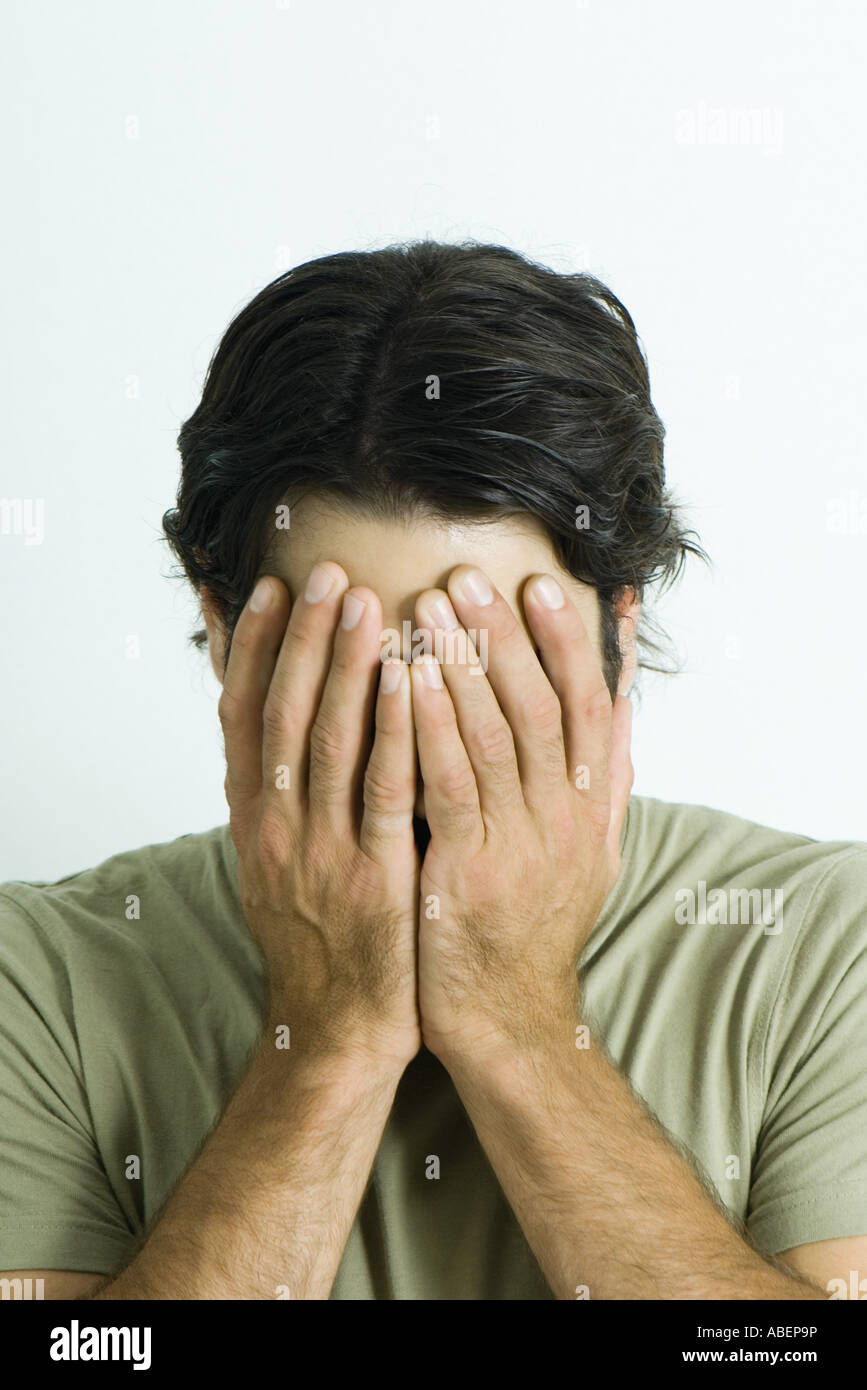 Man covering face with hands, portrait Stock Photo - Alamy