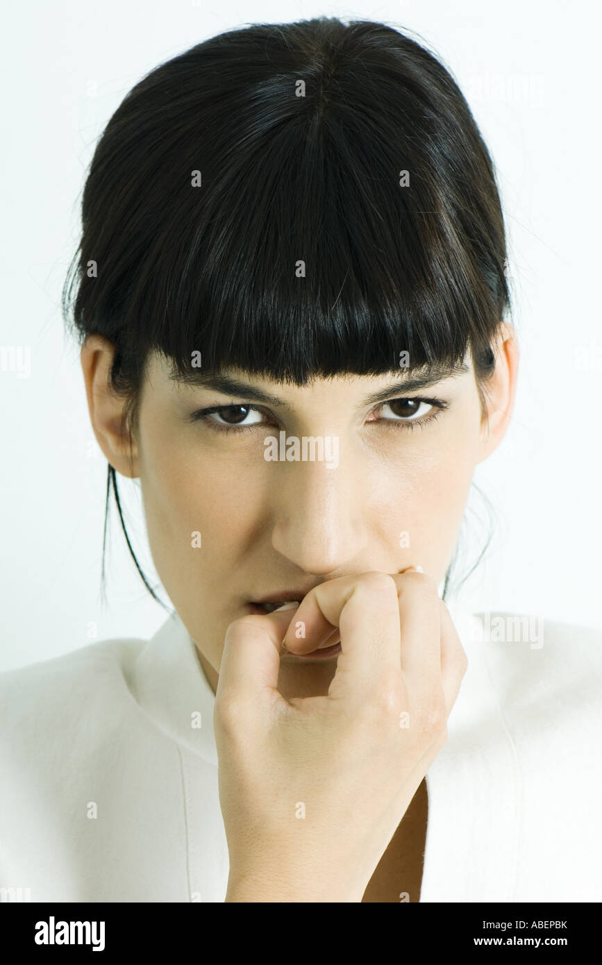Woman biting fingers, portrait Stock Photo - Alamy