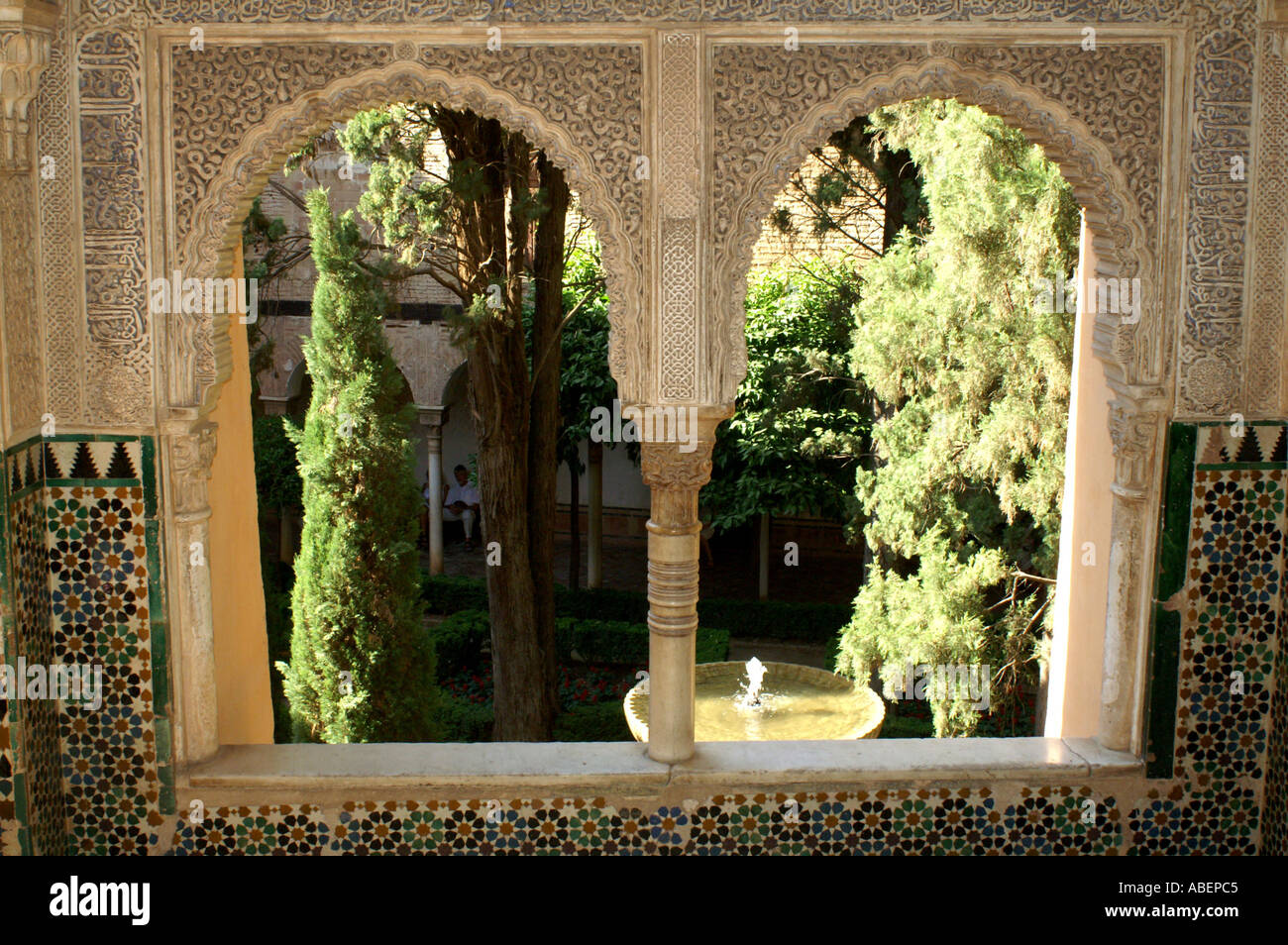Intricate arched plasterwork windows in moorish palace Alhambra Granada ...