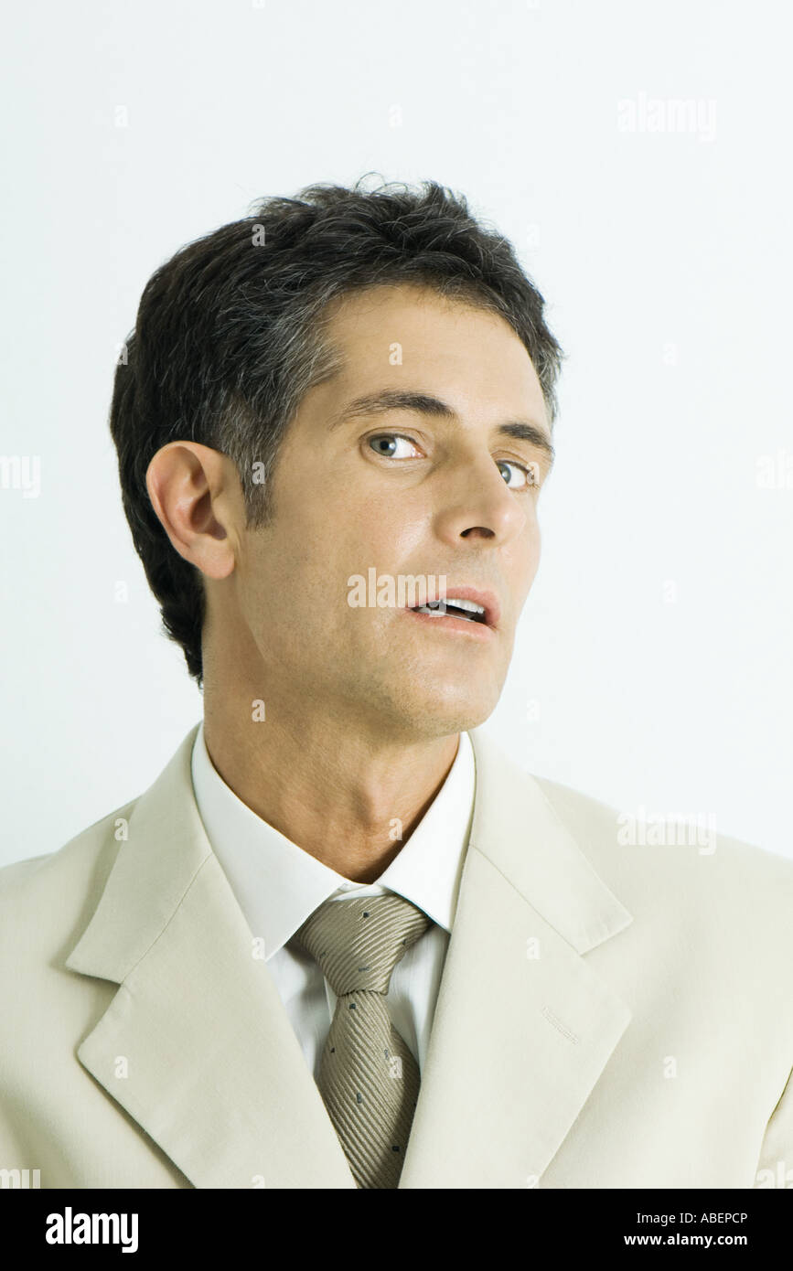 Man, head back, giving sideways look at camera, portrait Stock Photo ...