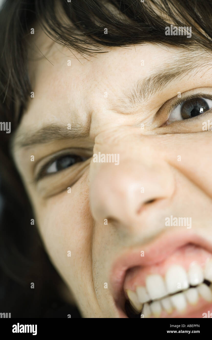 Teen boy making angry face, extreme close-up Stock Photo - Alamy