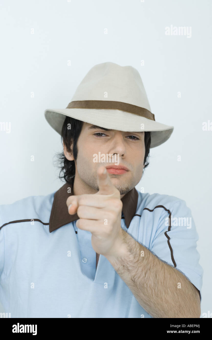 Young man wearing hat, pointing at camera Stock Photo - Alamy