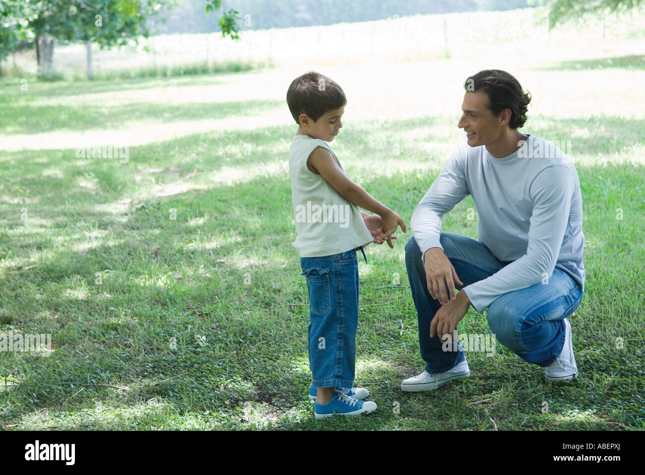 Boy and father talking outdoors Stock Photo - Alamy