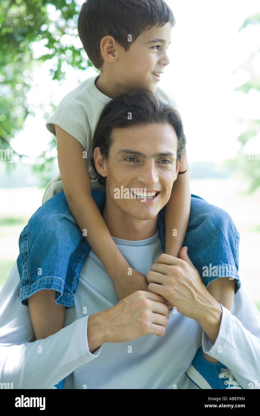 Boy and father, boy riding on man's shoulders Stock Photo - Alamy