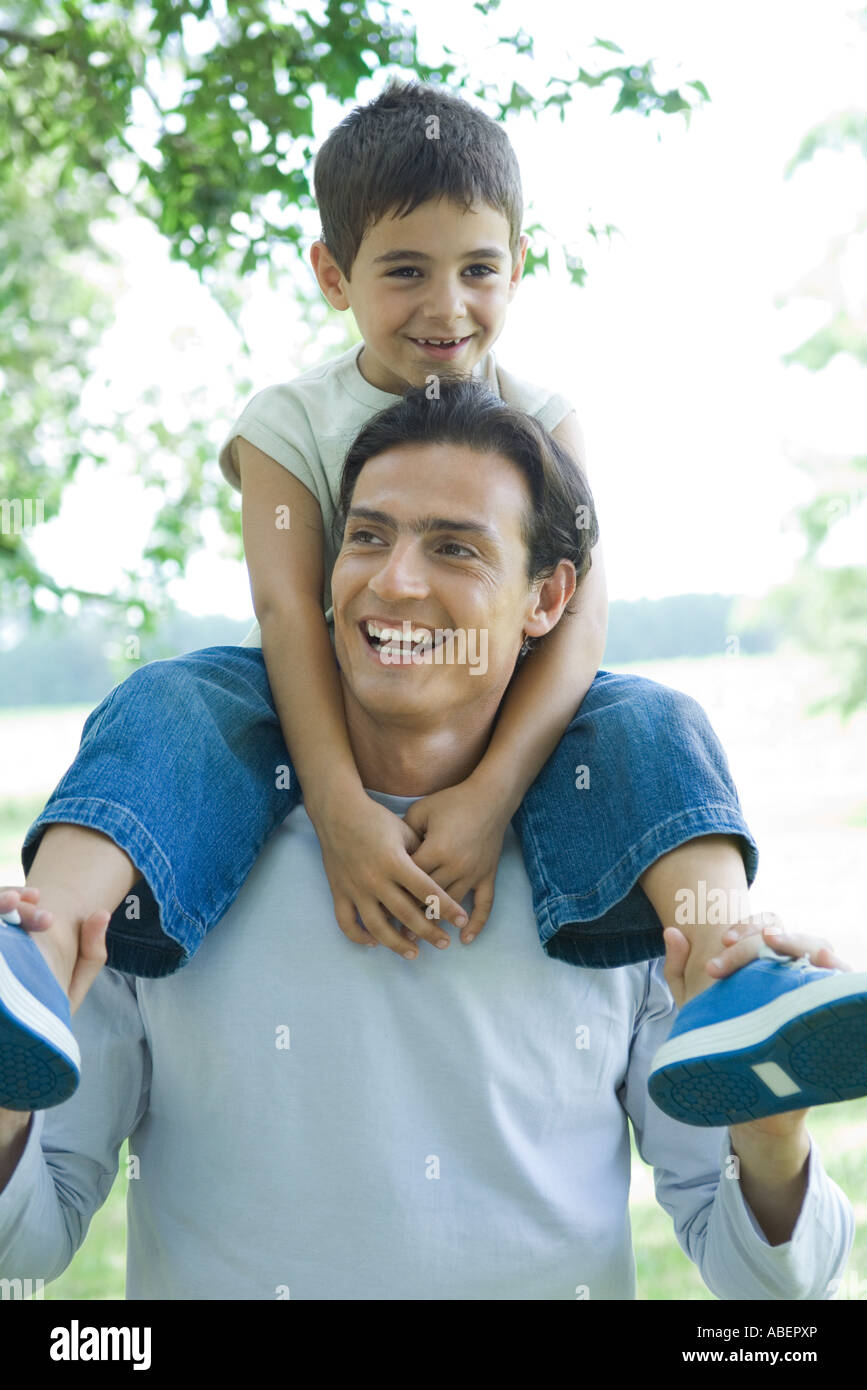 Boy and father, boy riding on man's shoulders Stock Photo - Alamy