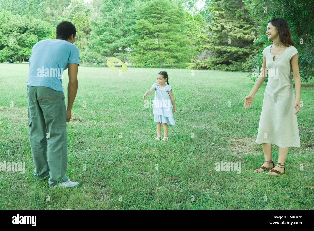 Family playing with plastic disc outdoors Stock Photo - Alamy