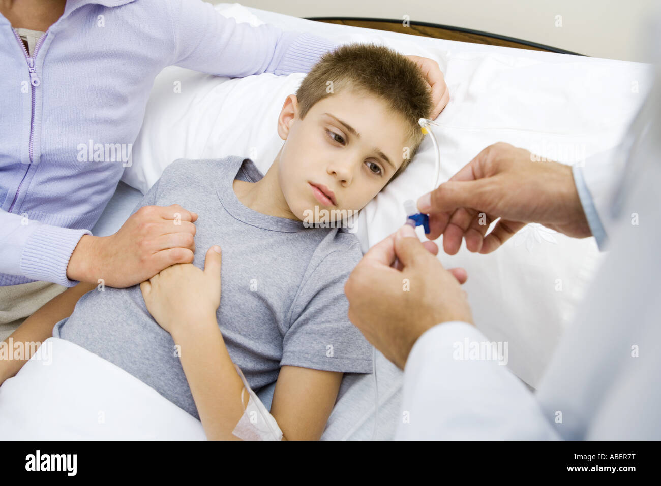 Boy having IV drip adjusted in hospital Stock Photo - Alamy Boy having IV drip adjusted in hospital Stock Photo - Alamy