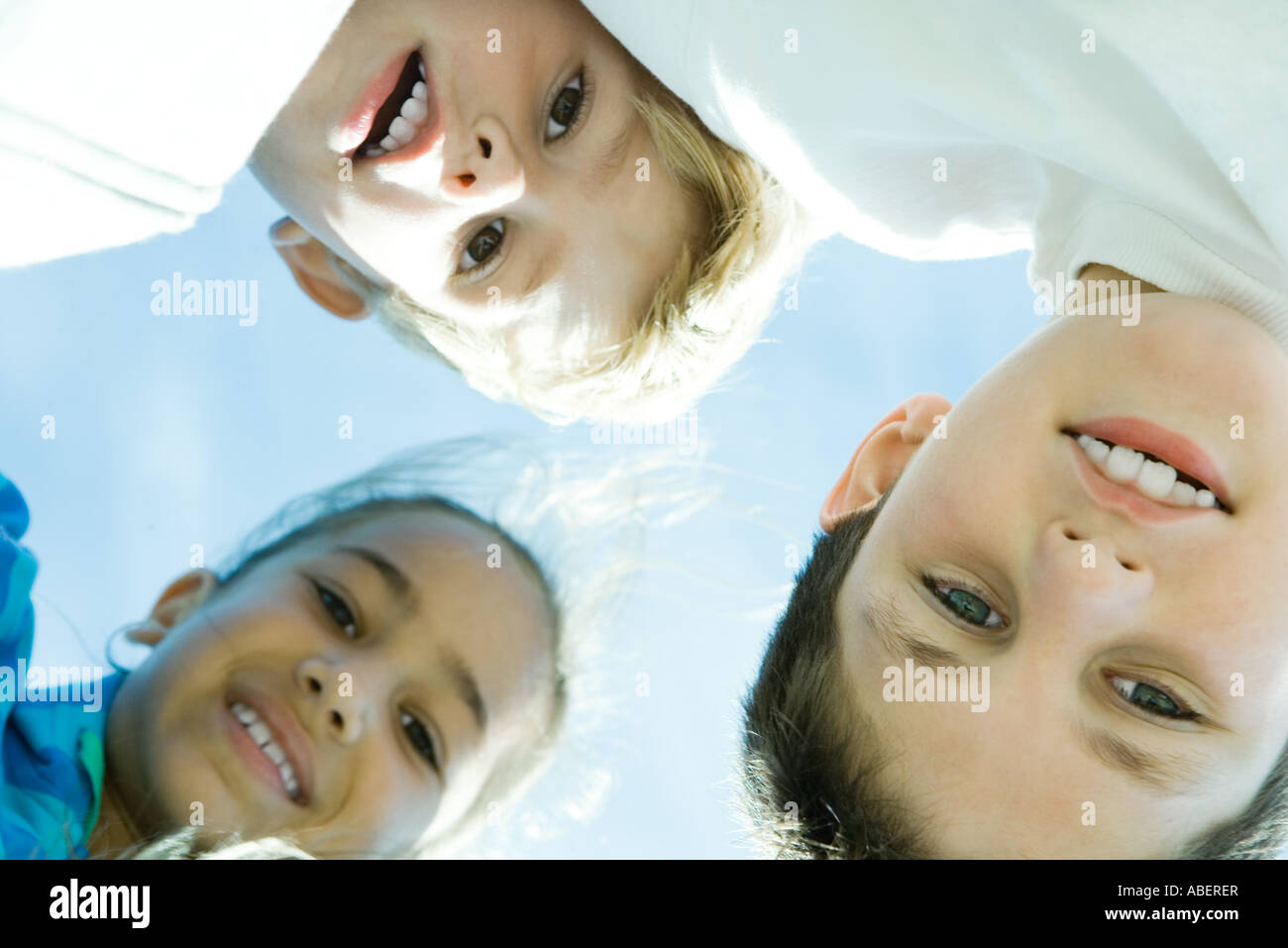 Three children, low angle view Stock Photo - Alamy