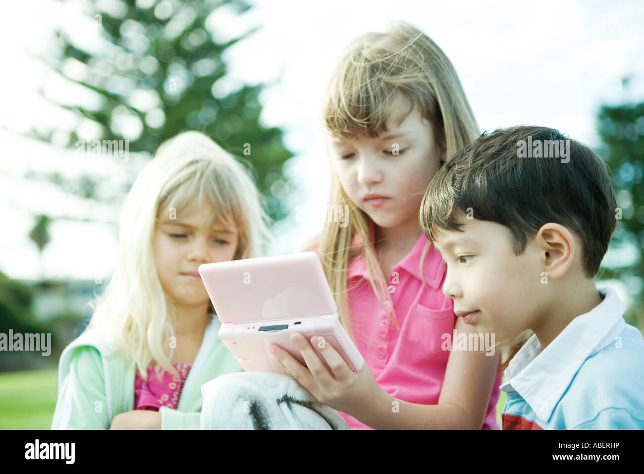 Children on playground, playing video game Stock Photo - Alamy