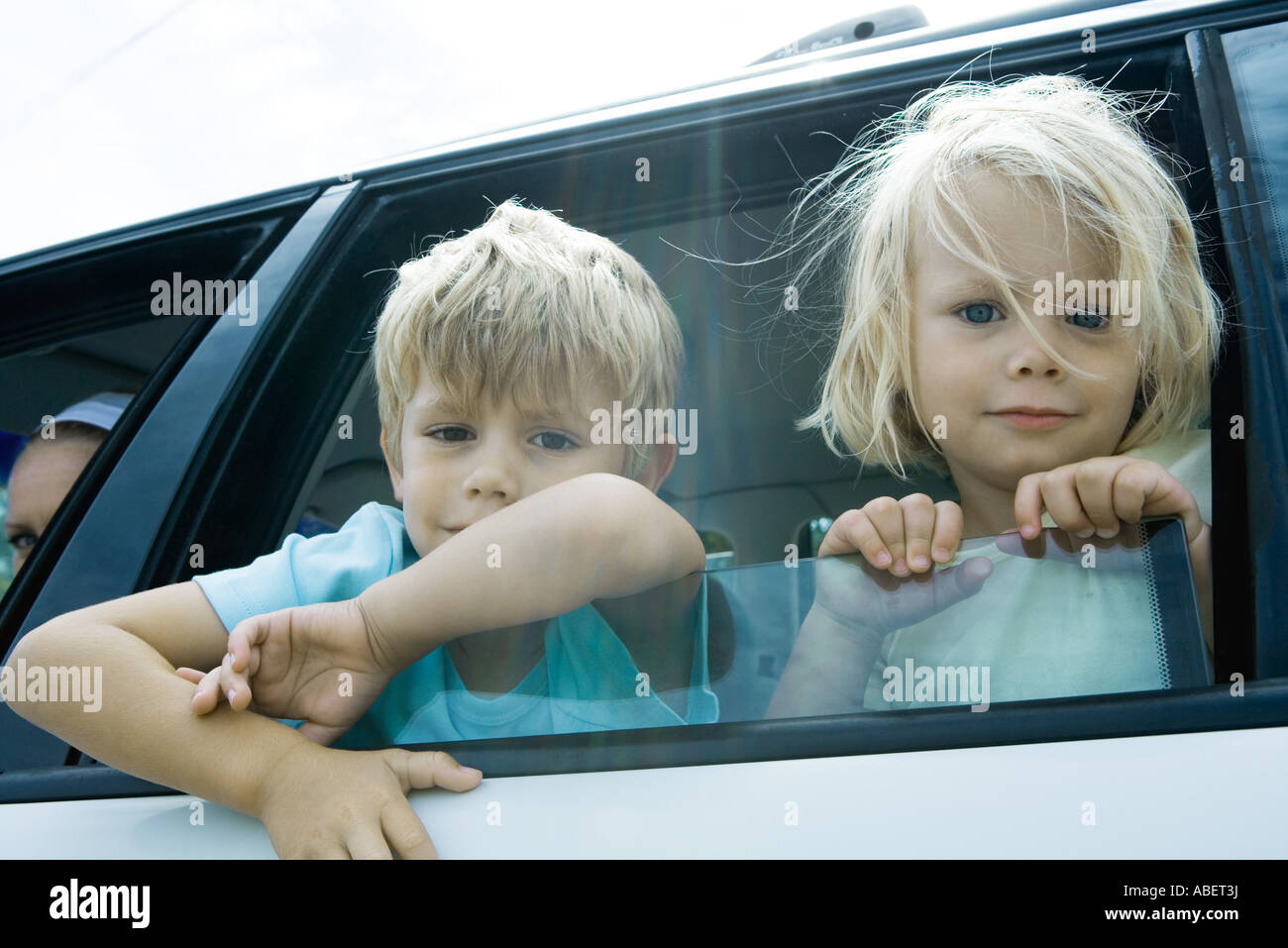 Children sticking heads out of car window Stock Photo - Alamy