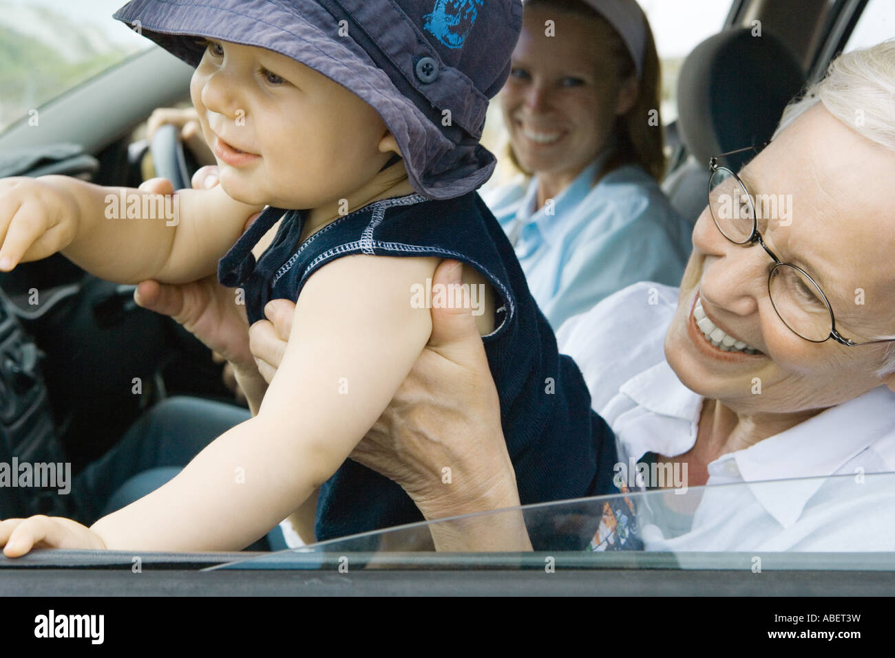 Woman holding baby in car Stock Photo - Alamy