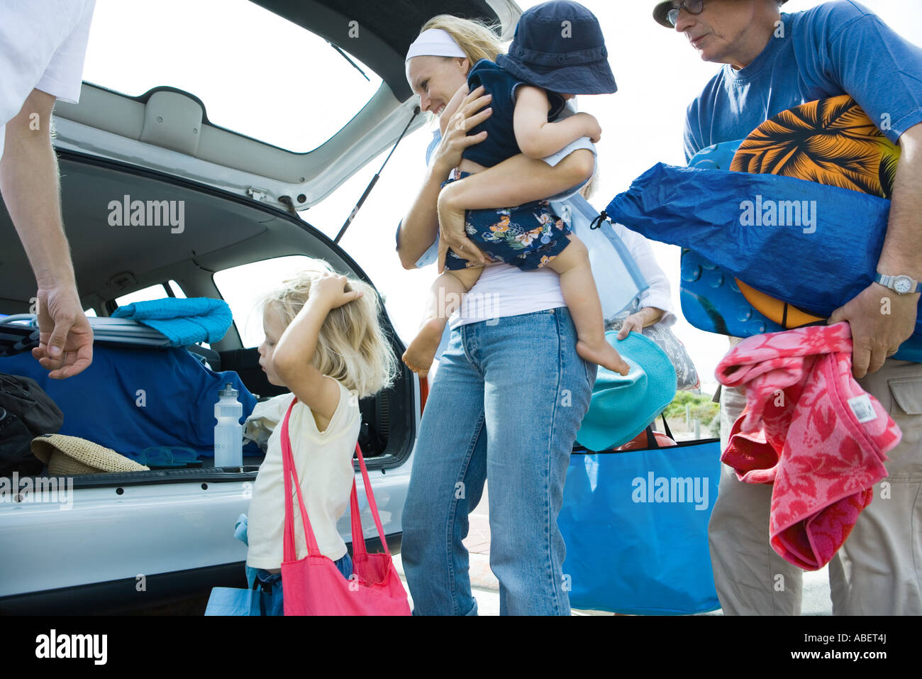 Family unloading trunk of car Stock Photo - Alamy