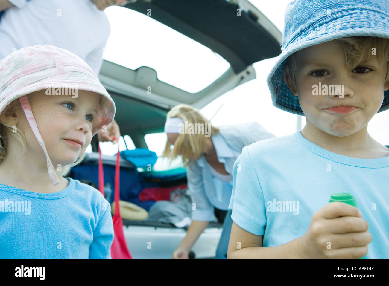 Children standing in front of trunk of car Stock Photo - Alamy