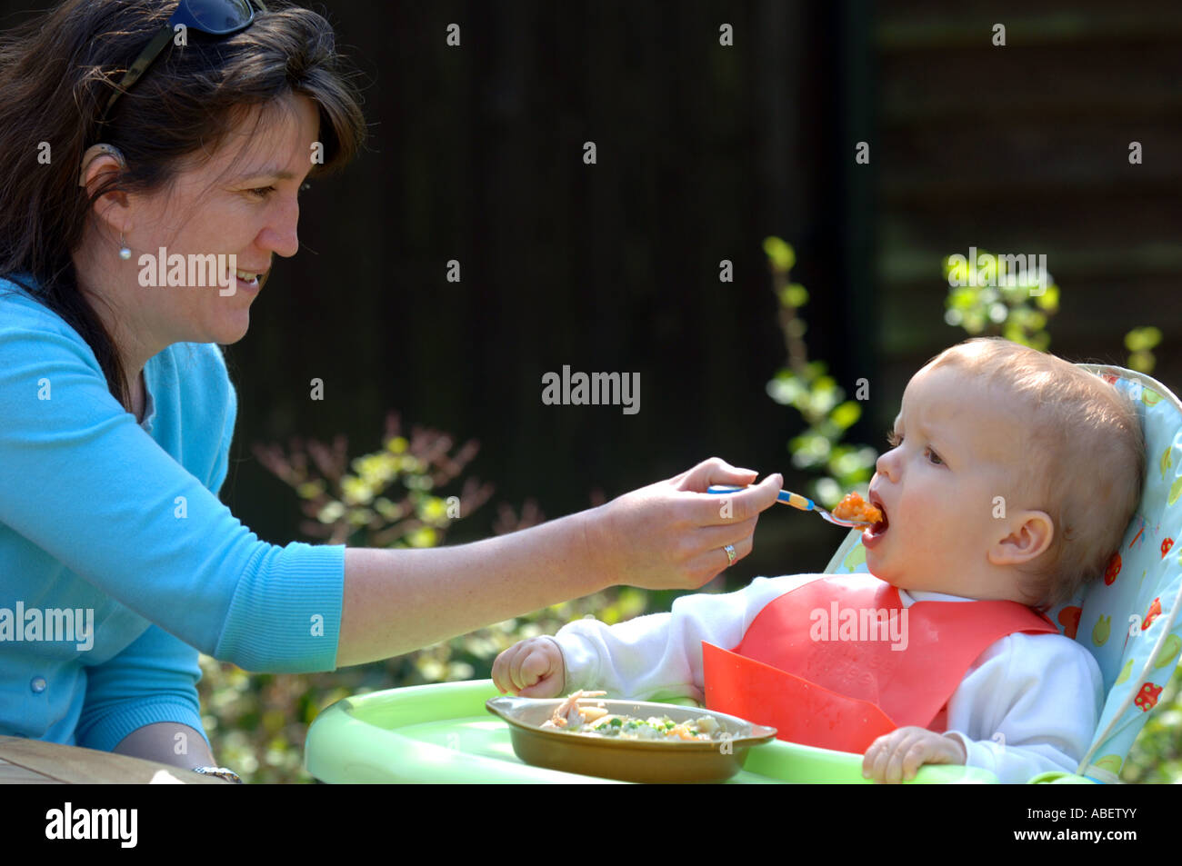 Baby feeding, mother feeding her baby solid food Stock Photo - Alamy