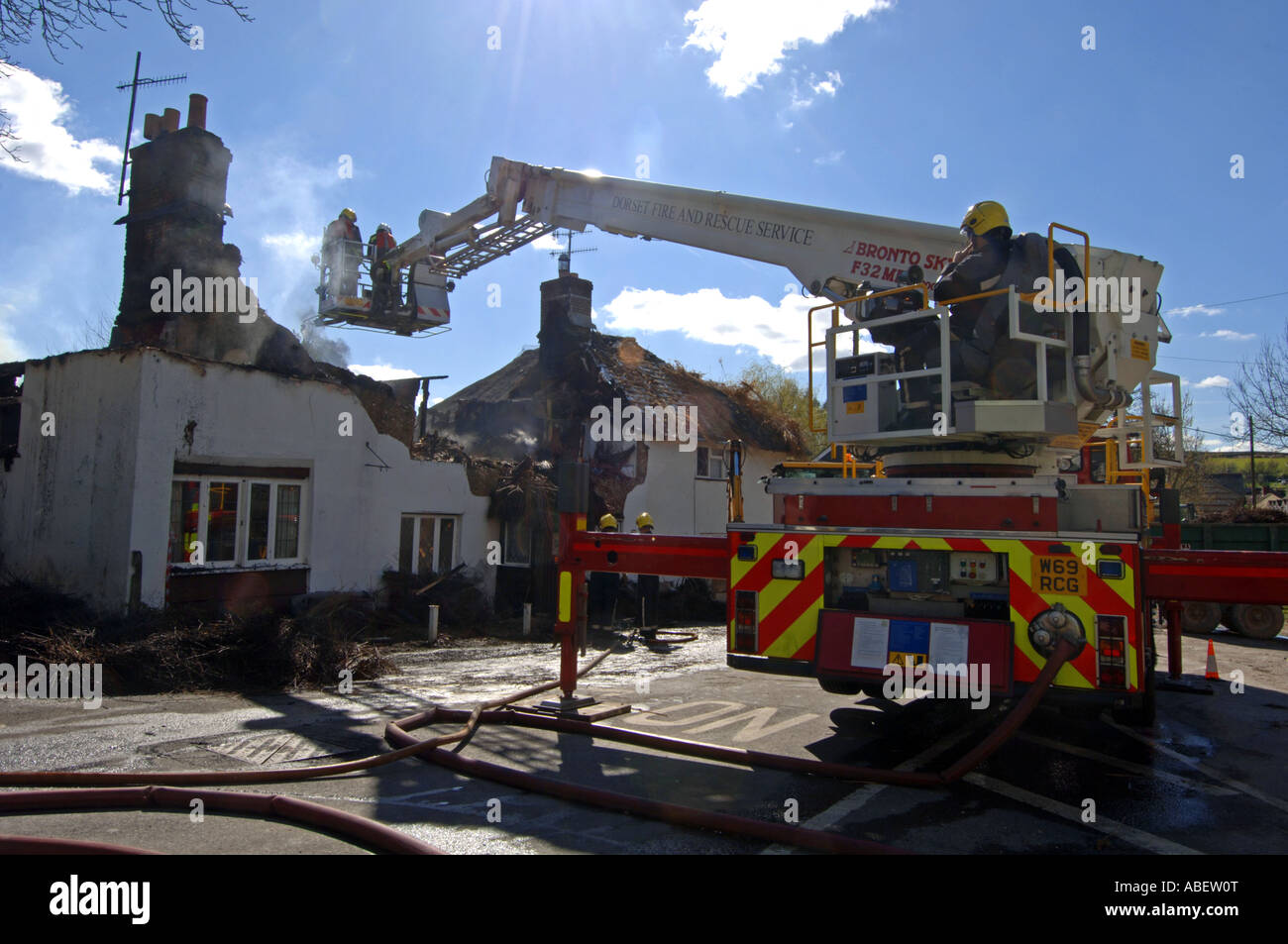 Fire engine outside a burnt out thatched cottage in Piddlehinton ...