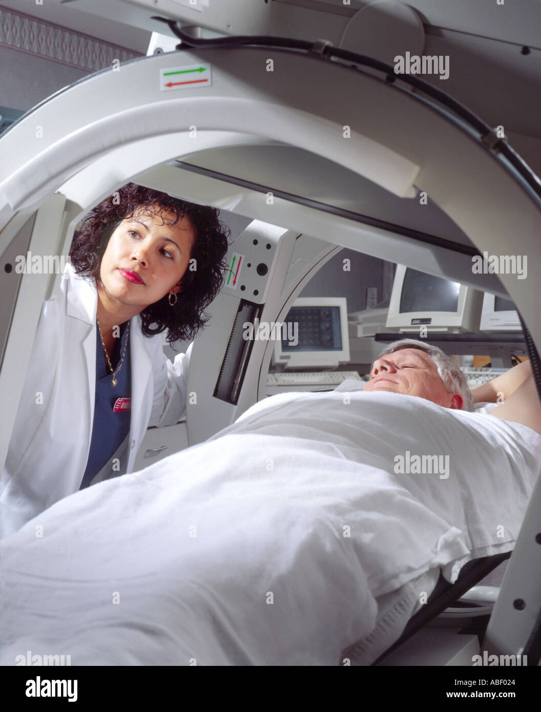 Nurse talking with with patient who is lying in open MRI unit Stock ...