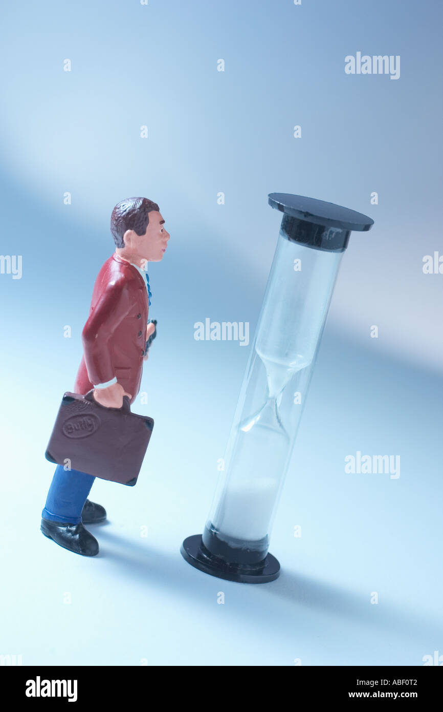 Businessman Figure and Sand Timer Stock Photo - Alamy