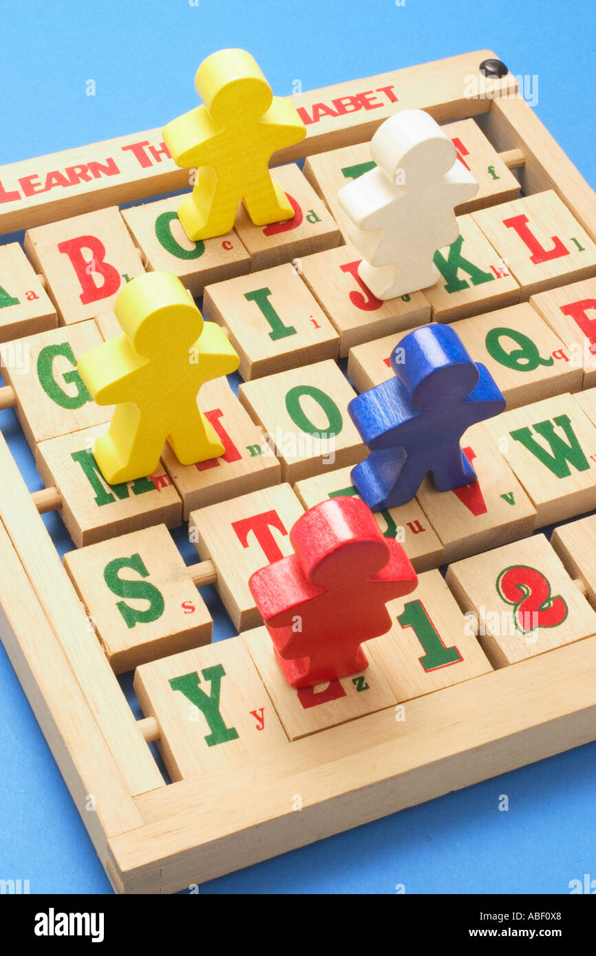 Wooden Children Figures on Alphabet Blocks Stock Photo - Alamy