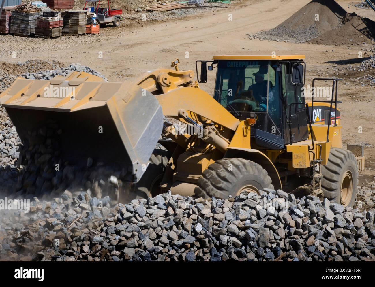 Bulldozer dumping rocks Stock Photo - Alamy