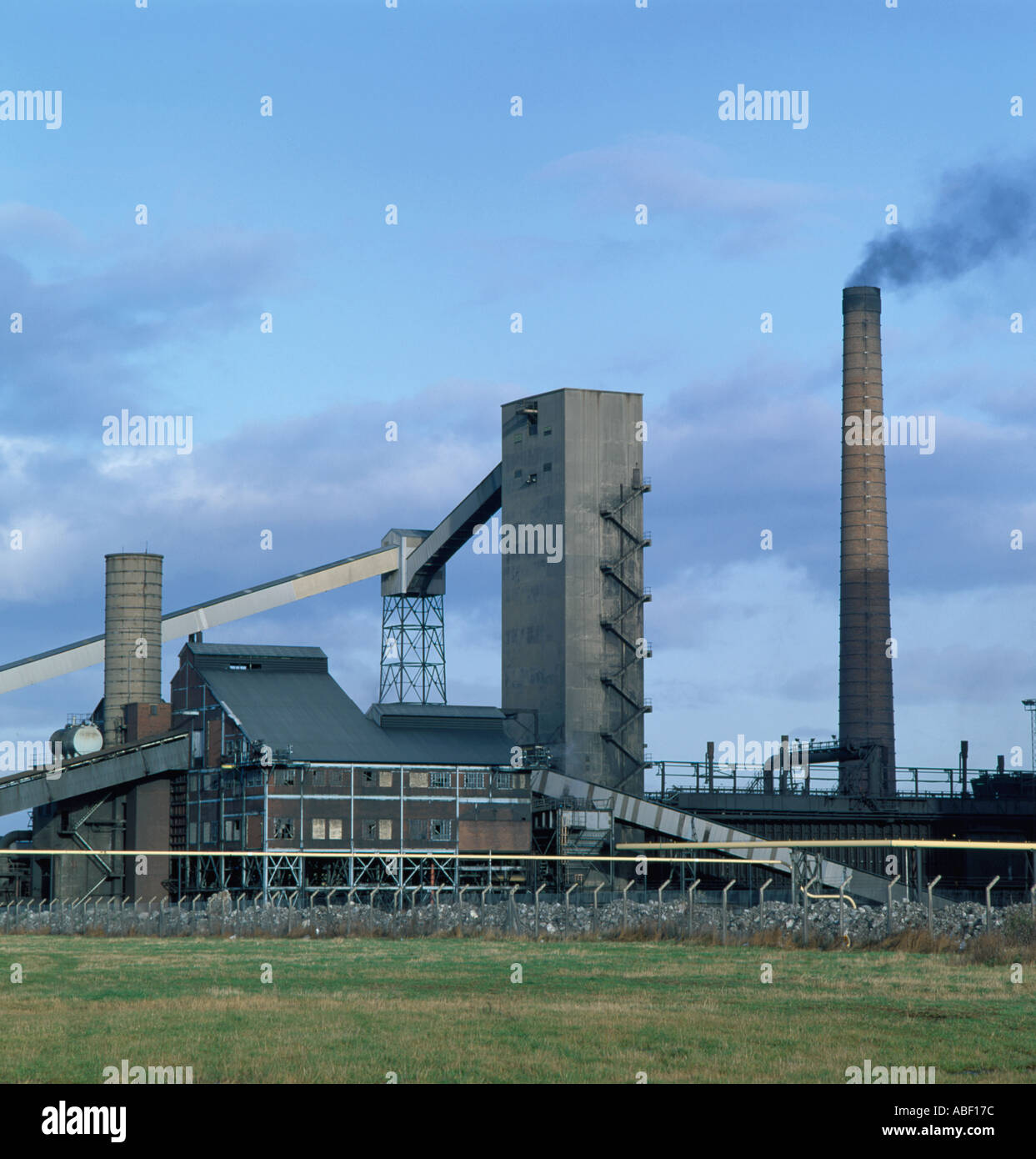 Reinforced concrete silo and brick chimney stack at a steelworks ...