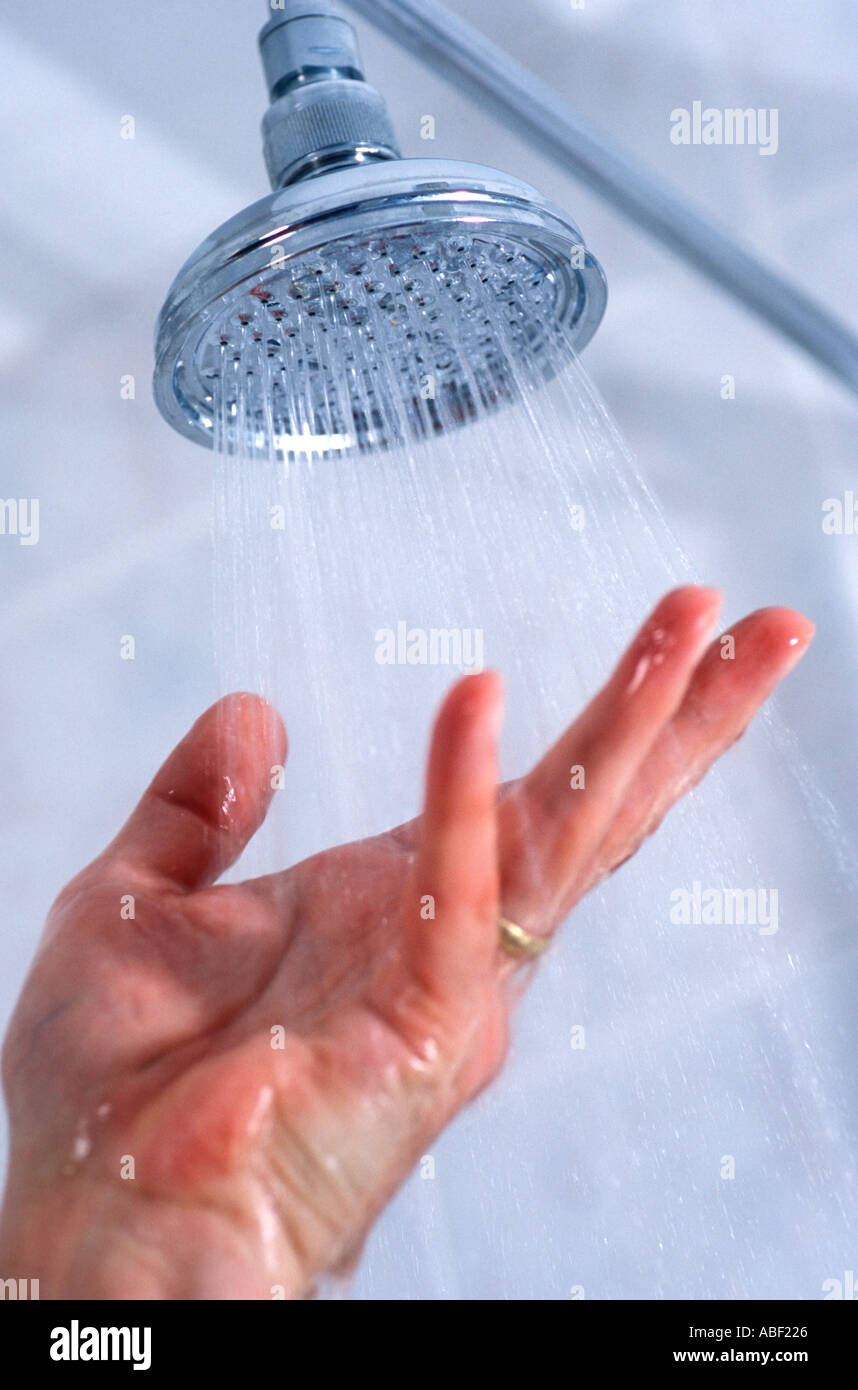 Checking the temperature of a shower Stock Photo - Alamy