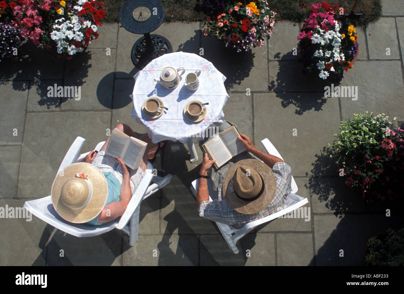 Couple drinking tea on garden patio Stock Photo - Alamy