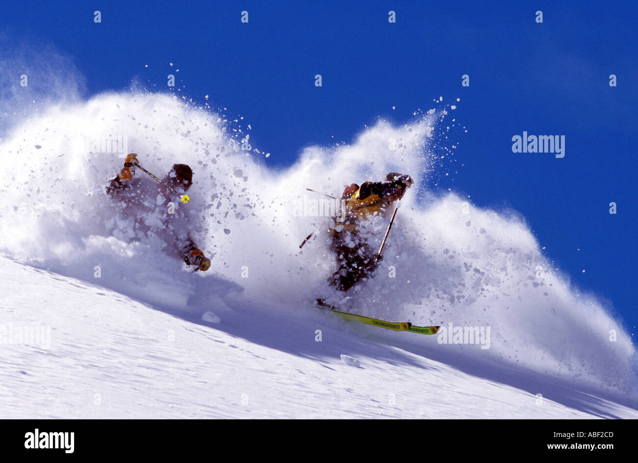 Two skiers in deep powder snow Stock Photo - Alamy
