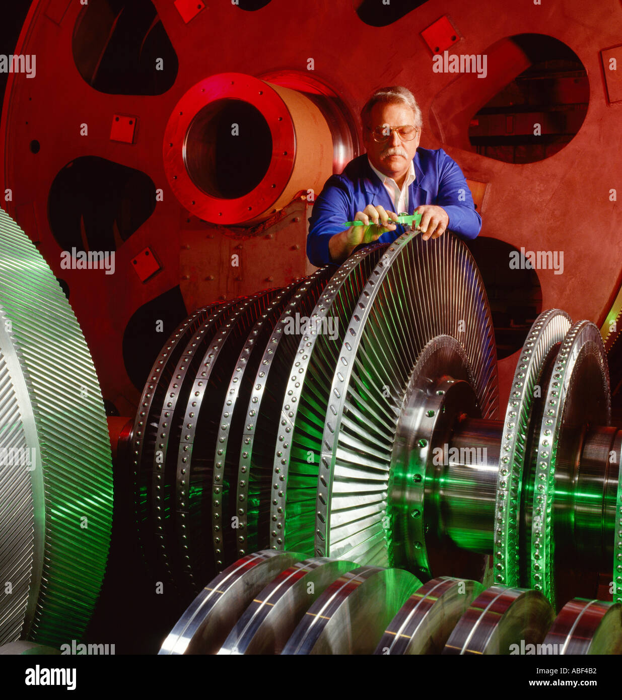 Turbine construction; an engineer manually measures part of a ship ...