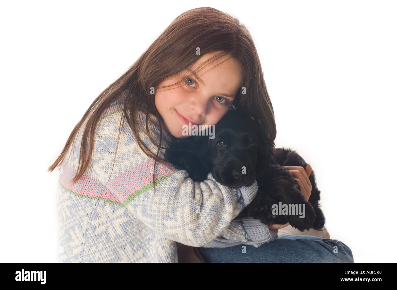 nine year old girl cuddles two month old black cocker spaniel pet Stock ...