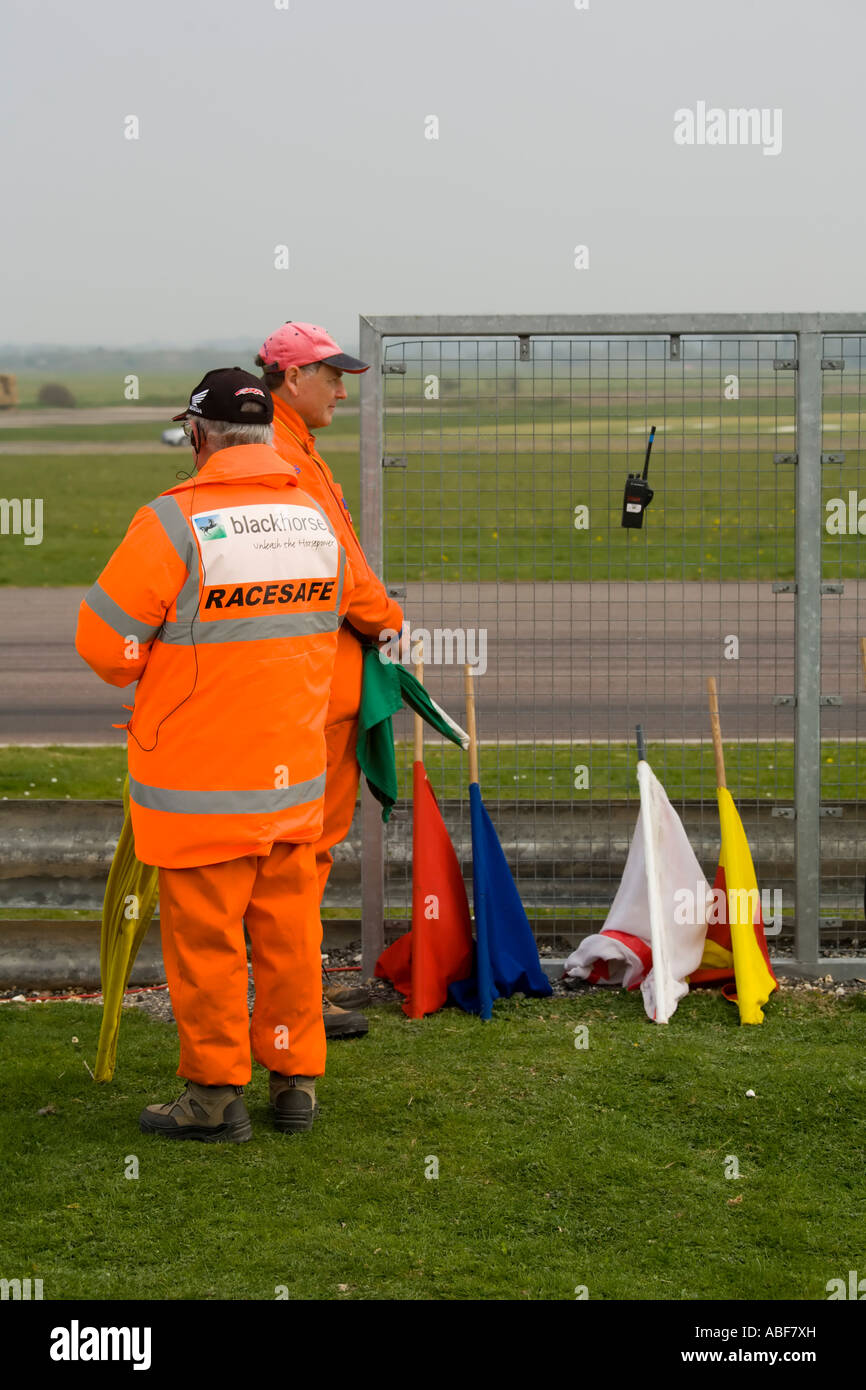 Safety marshals and coloured flags at race track Stock Photo - Alamy