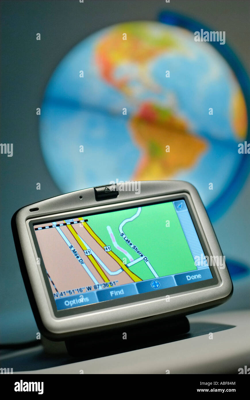 GPS SATELLITE NAVIGATION INSTRUMENT IN FRONT OF GLOBE Stock Photo - Alamy