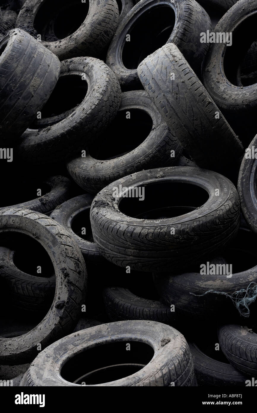 A pile of abandoned motor car tyres (tires) are left on wasteland in ...