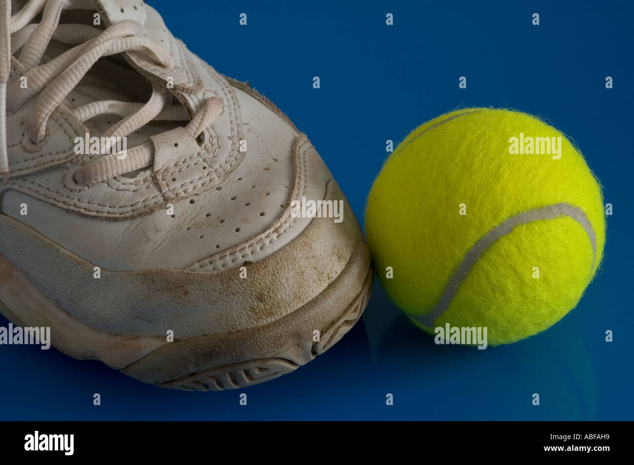 Tennis shoe and ball Stock Photo - Alamy