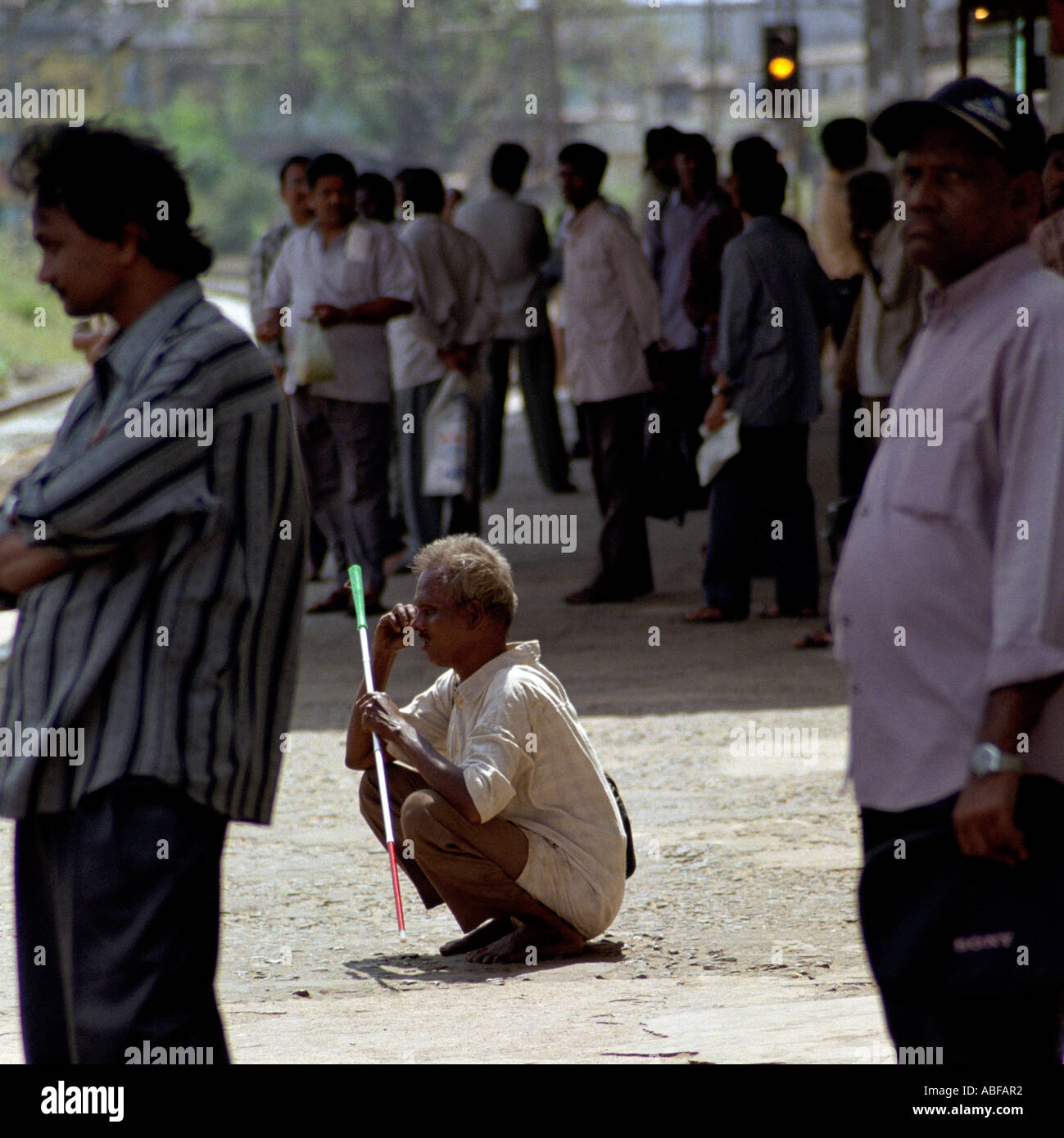 An old man waiting at a railway station in Chennai Tamilnadu India ...