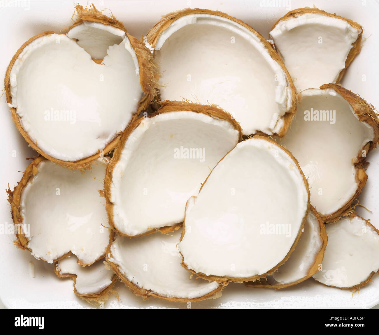 Raw coconut split open Stock Photo - Alamy